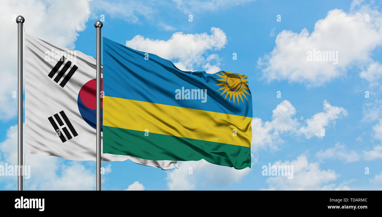 South Korea and Rwanda flag waving in the wind against white cloudy ...