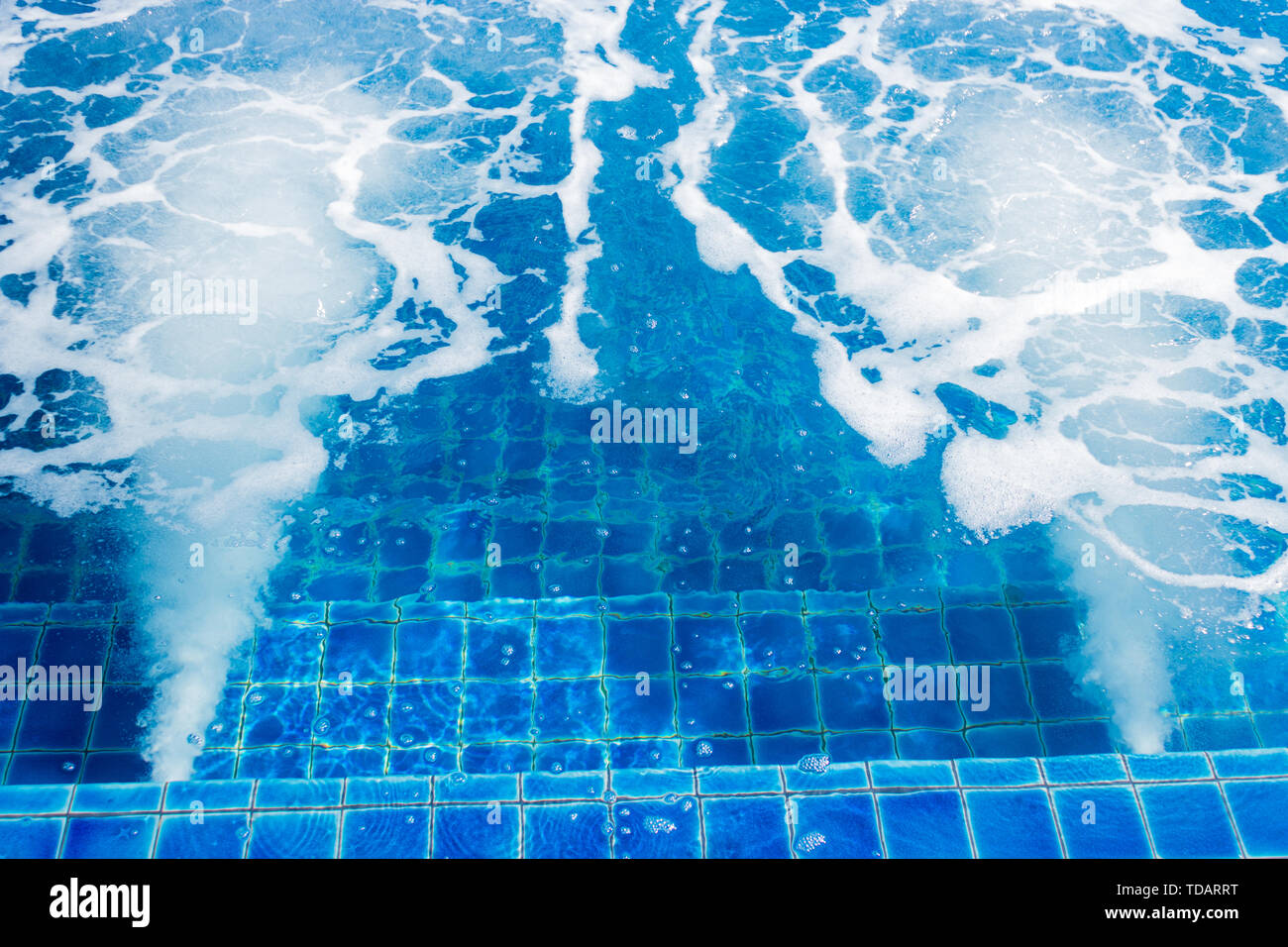 Massage and spa swimming pool with bubbles blue water Stock Photo - Alamy