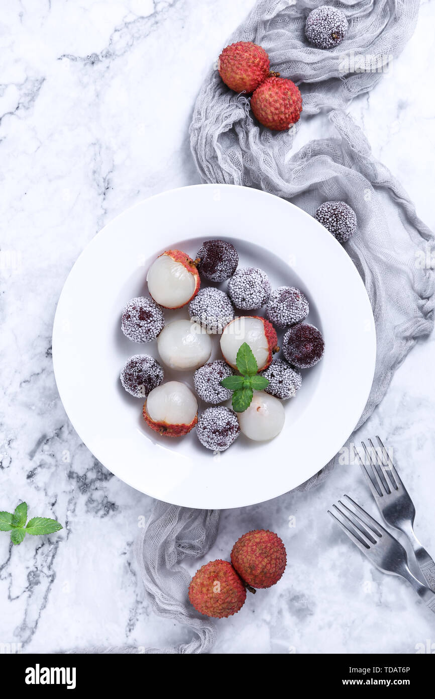 Frozen plum and fresh lychee Stock Photo - Alamy