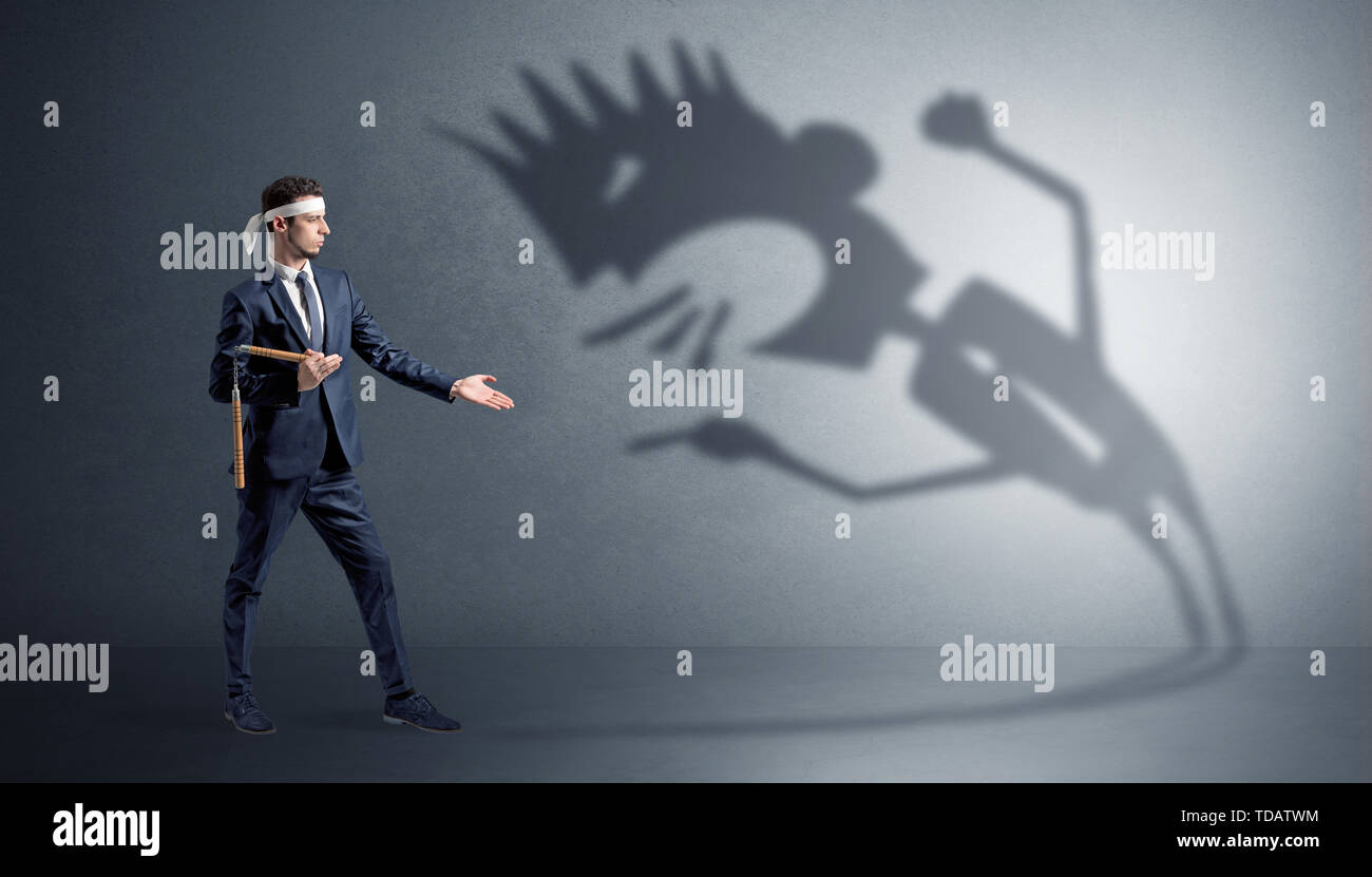 Young karate man fighting with a big black scary shadow Stock Photo - Alamy