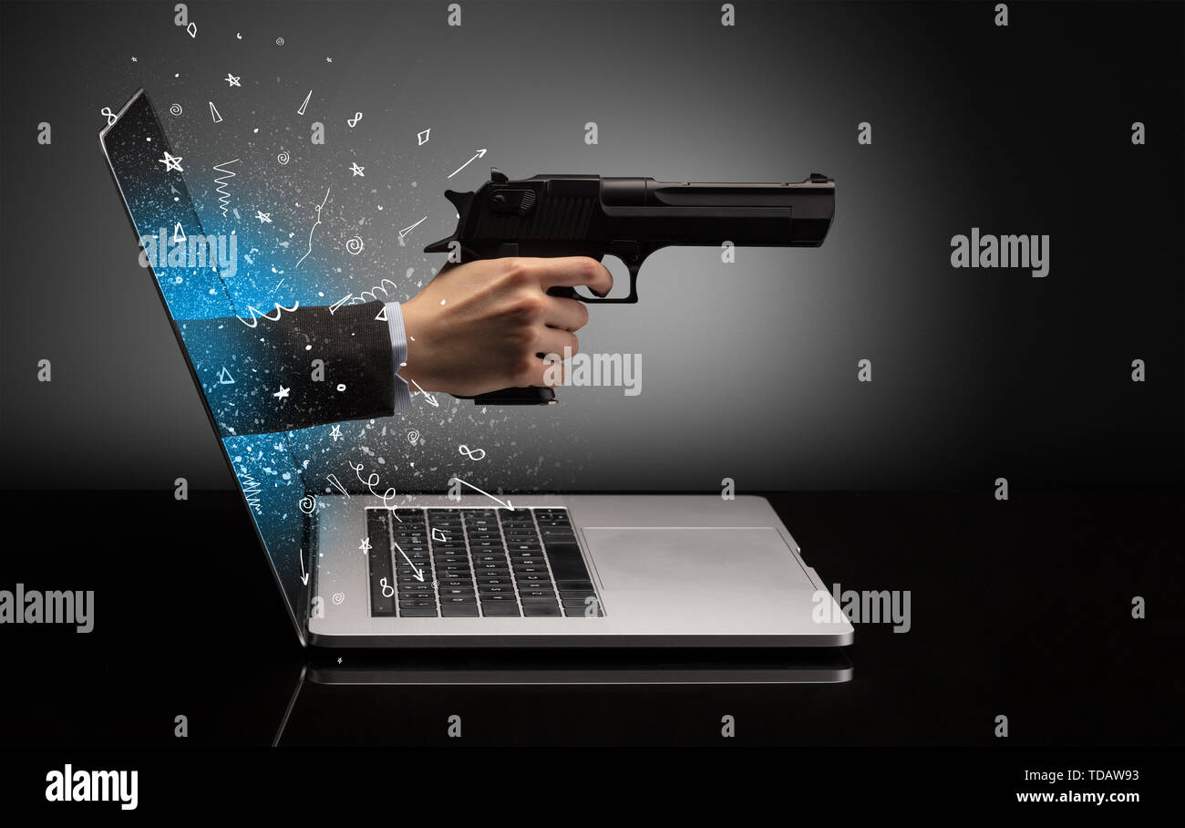 Hand with gun coming out of a laptop with sparkling effects Stock Photo ...