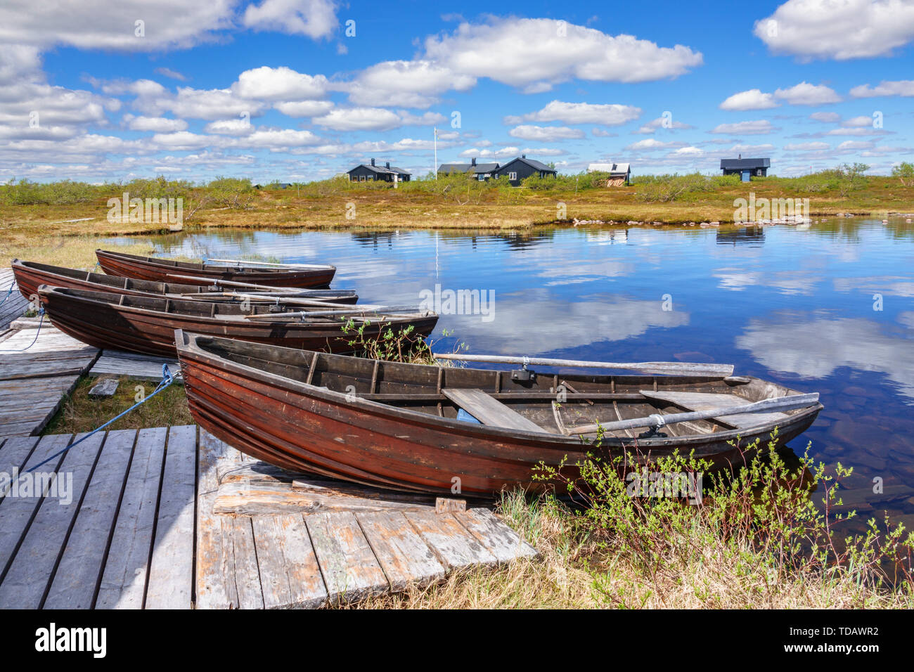 Rowing boats on a jetty by a lake Stock Photo - Alamy