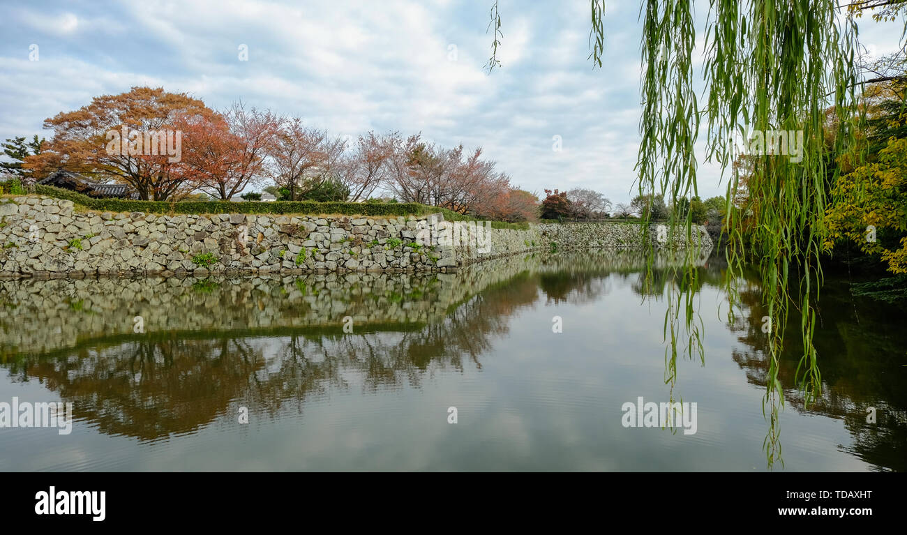 Moat of Himeji Castle in autumn. The castle is Japan unique ...