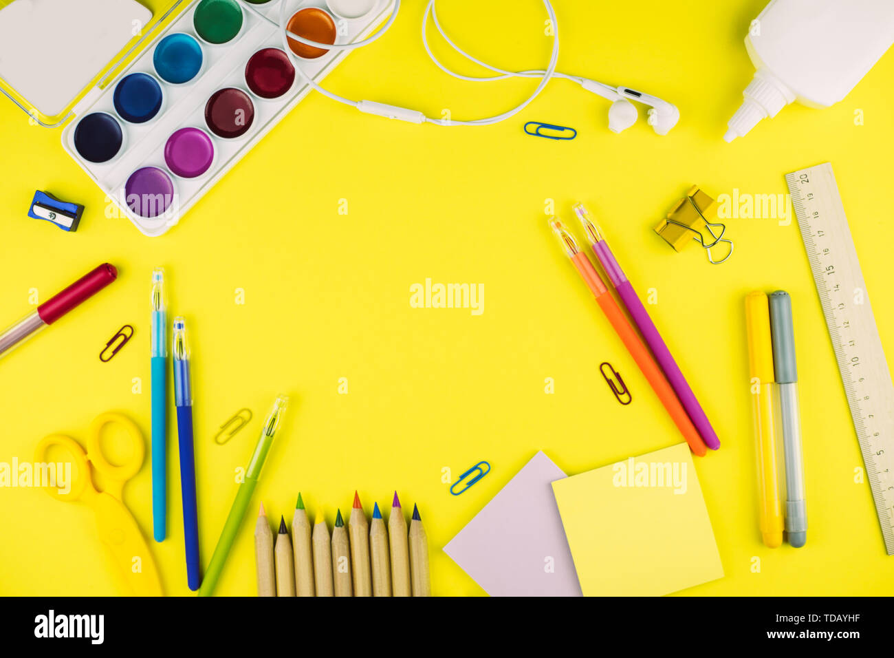 Different school supplies on bright yellow paper background Stock Photo ...