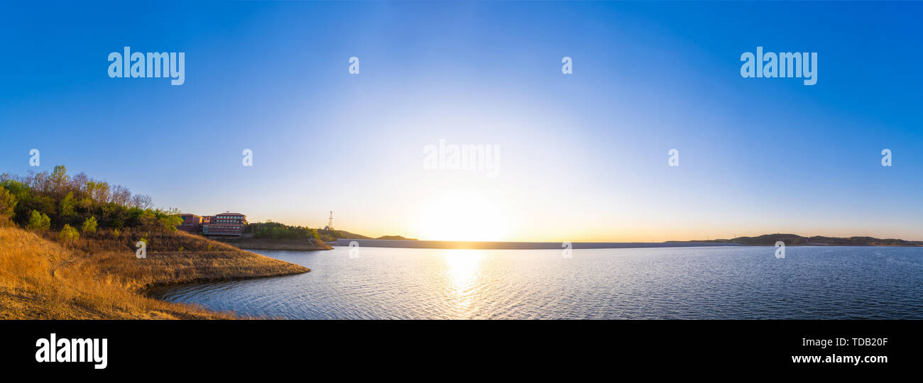 A panoramic view of the water surface of a quiet, smooth sunset Stock ...