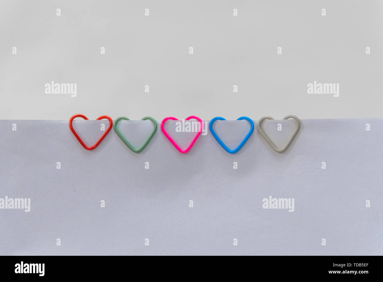 Heart-shaped paperclip background Stock Photo - Alamy