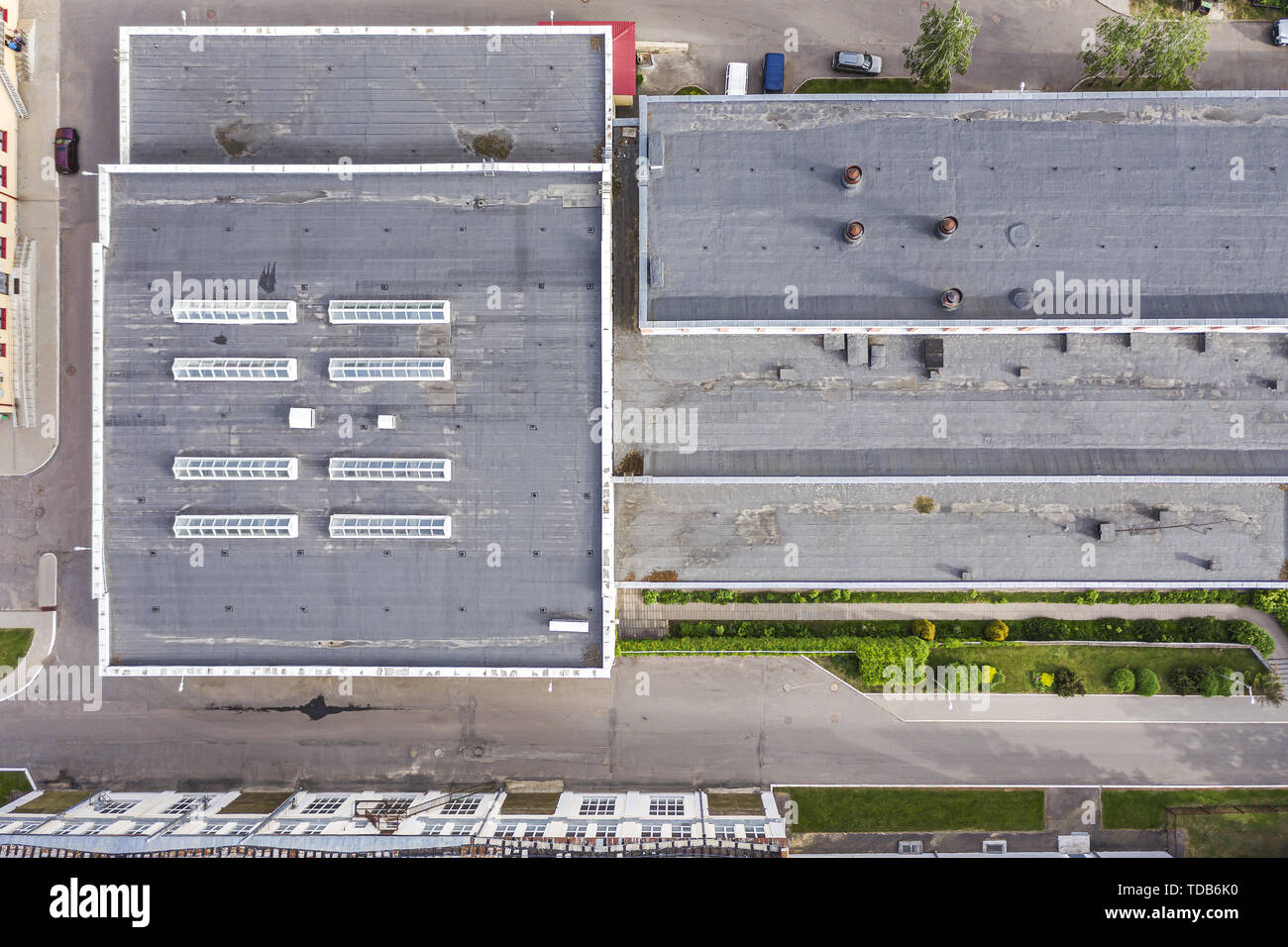 shingles roof of the industrial building with skylights. aerial top ...