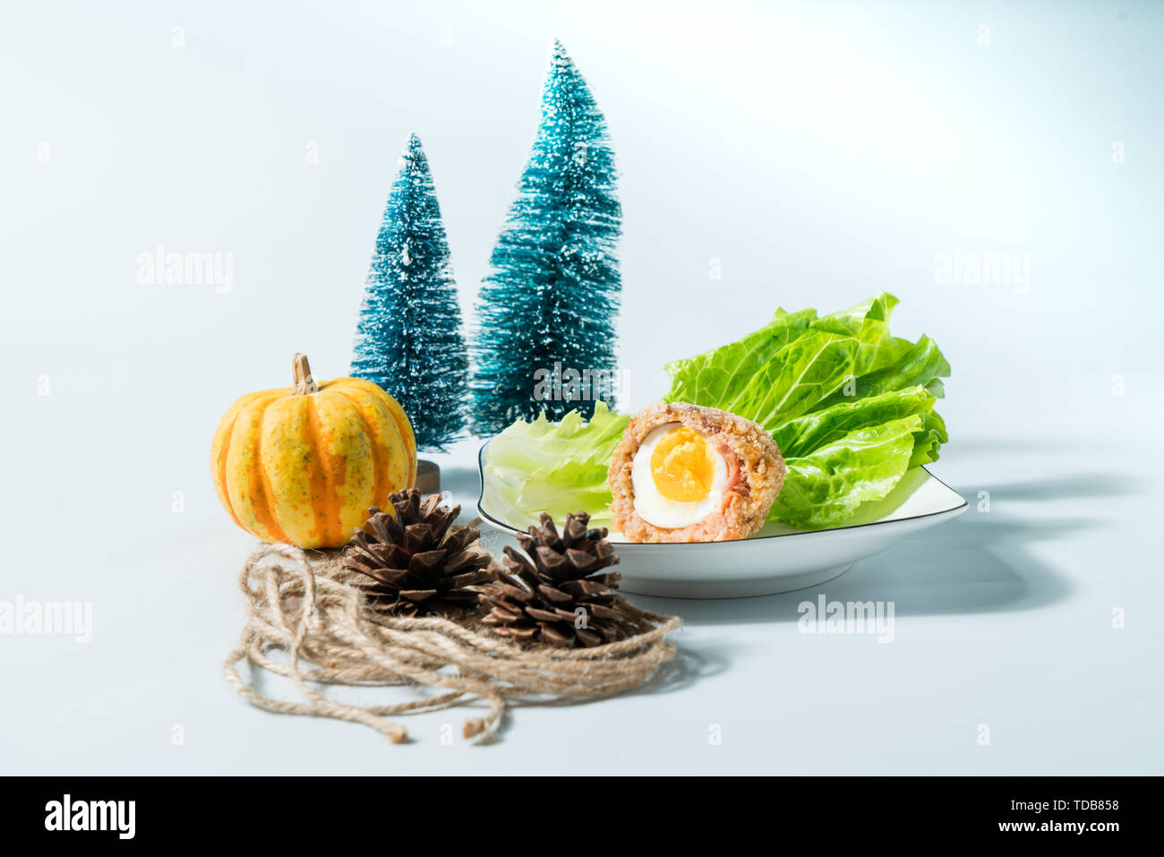 Scottish egg pendulum plate with white background Stock Photo - Alamy