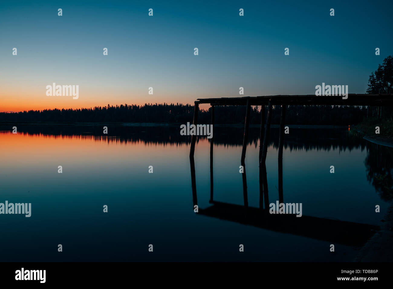wooden bridge from which jump into the lake at night Stock Photo - Alamy