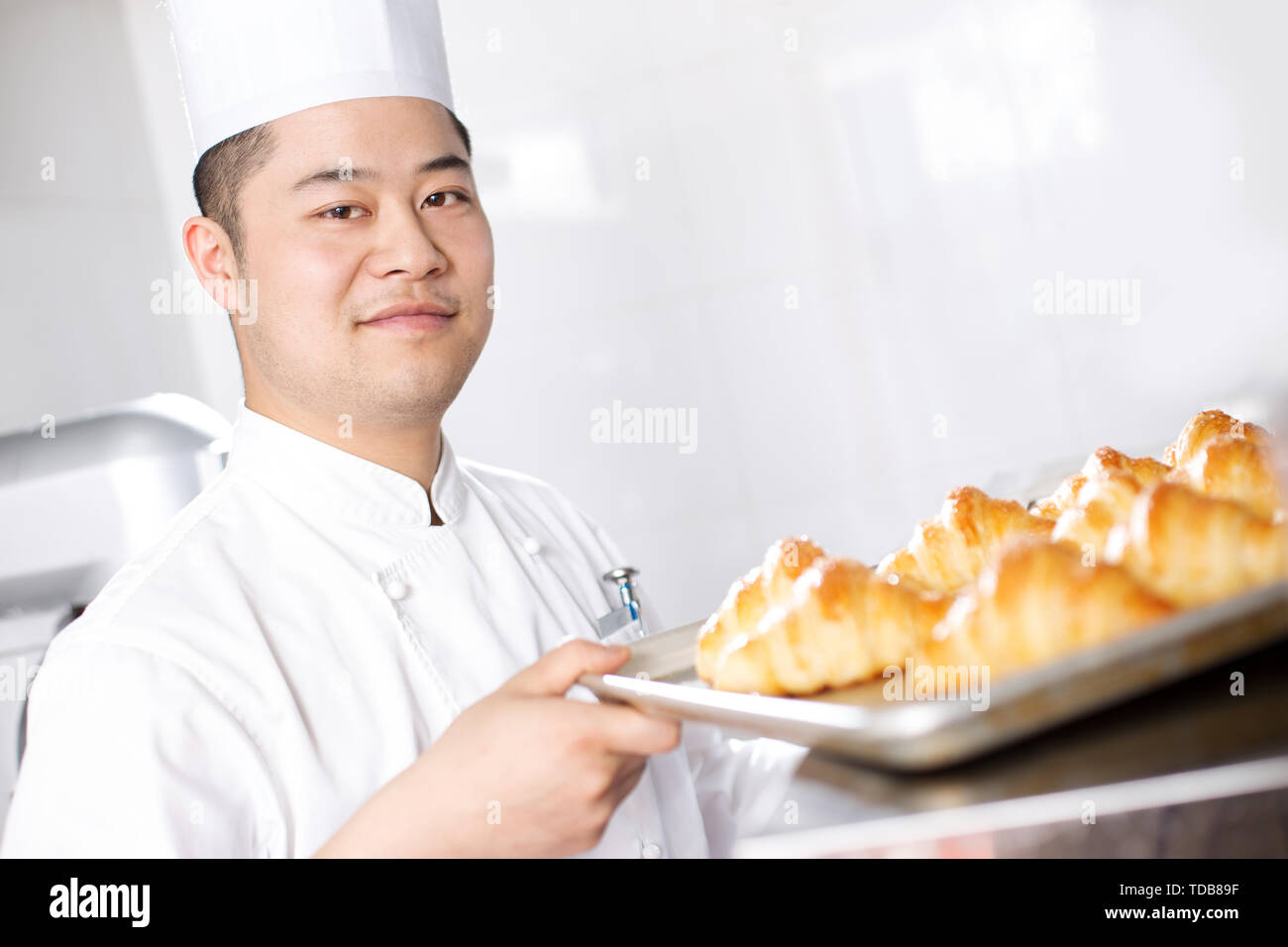 young chinese man chelf making bread in kitchen Stock Photo - Alamy