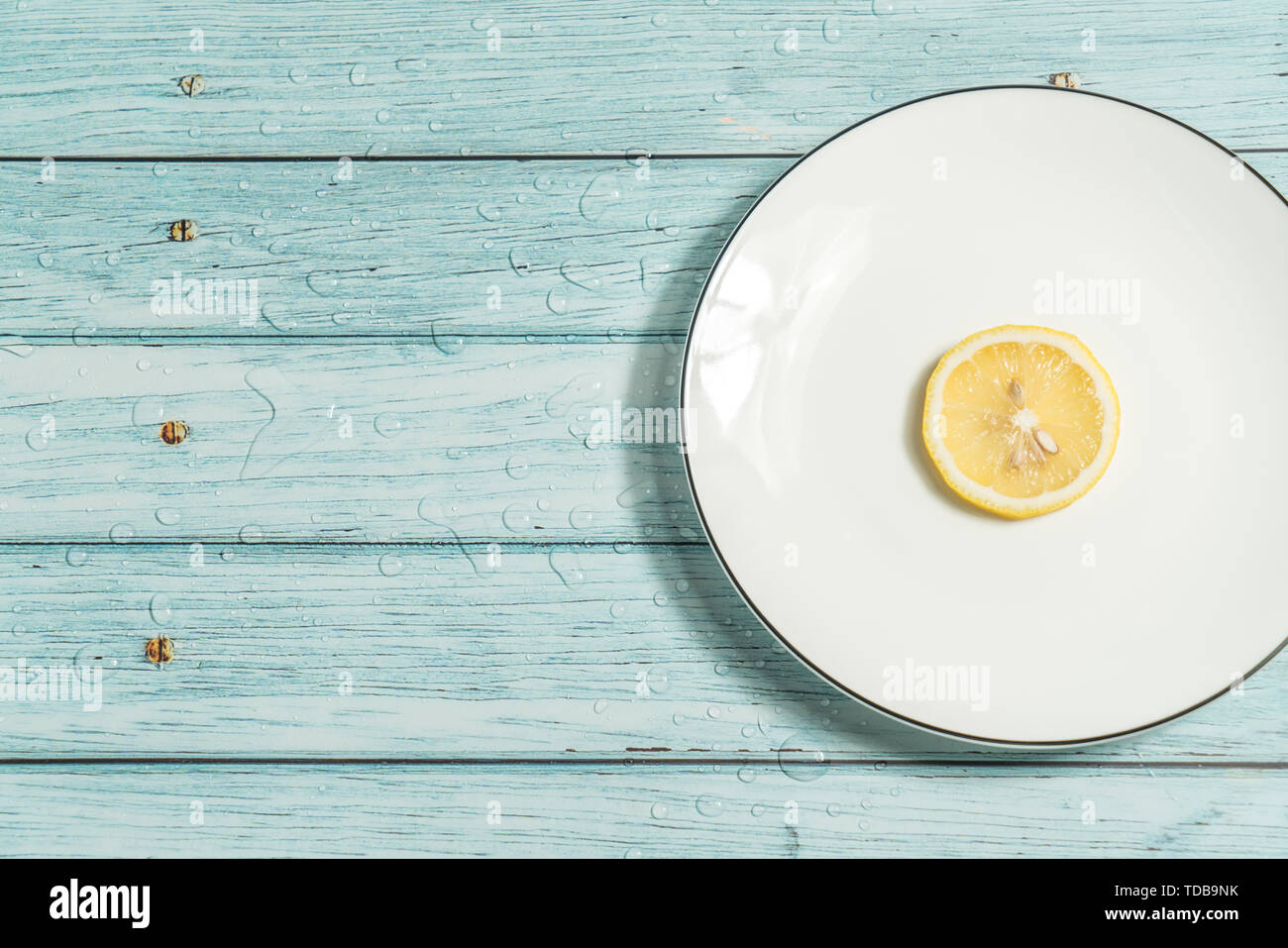 Lemon with teal wood pattern background Stock Photo - Alamy