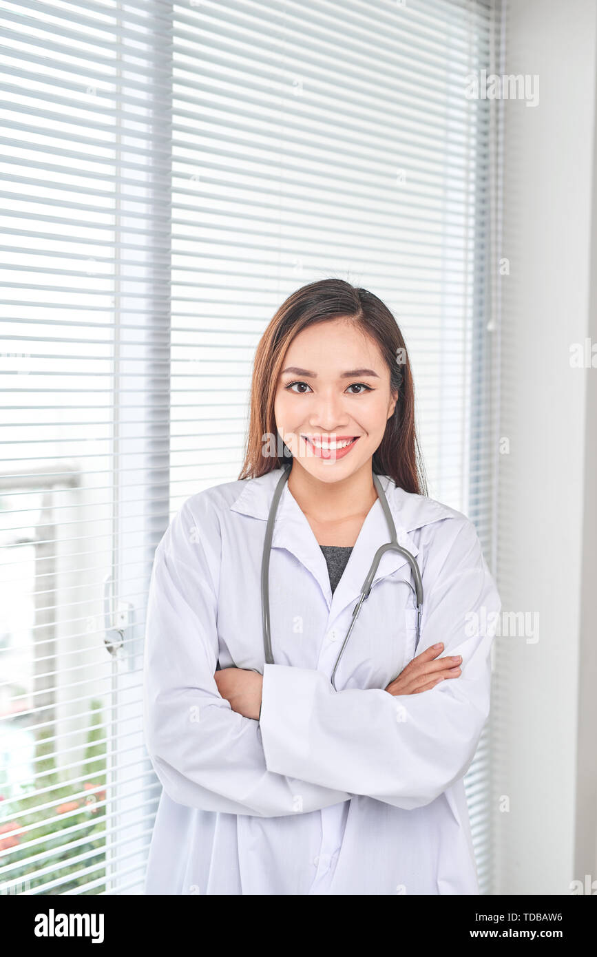 Portrait of smiling female doctor standing posing in her hospital ...