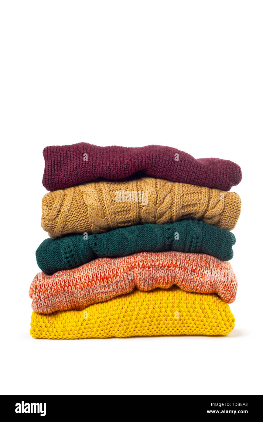 Stack of various sweaters isolated on white background Stock Photo - Alamy