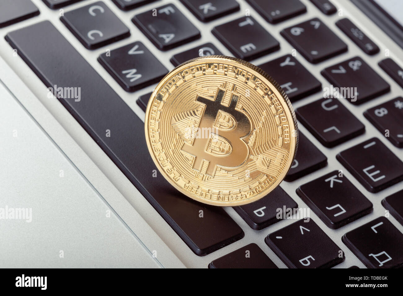 Golden bitcoin physical coin symbol on keyboard Stock Photo - Alamy