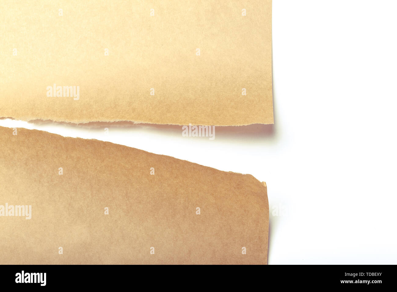 Brown package paper torn to reveal white panel Stock Photo - Alamy