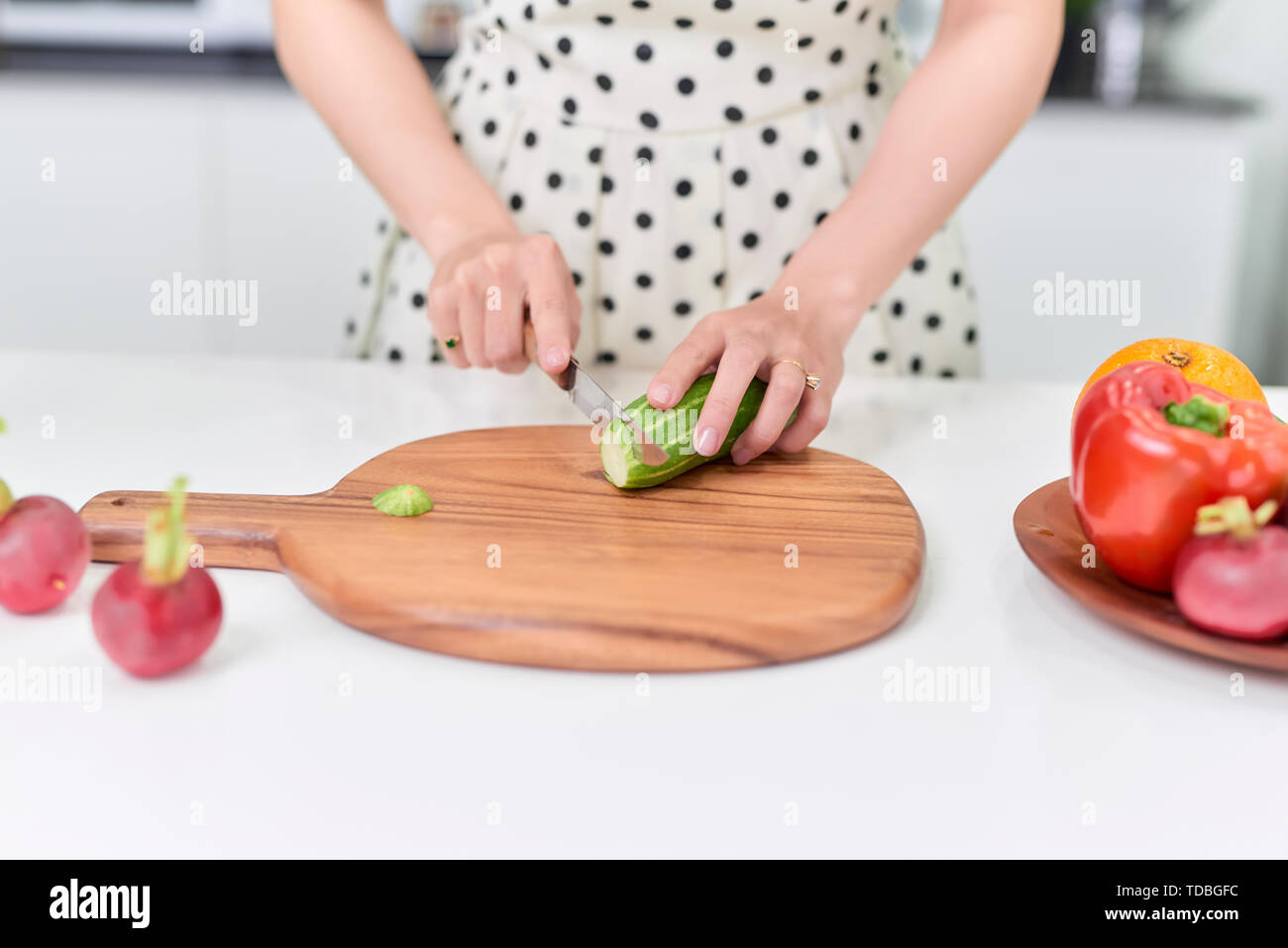 Woman preparing salad chopping vegetables hi-res stock photography and ...