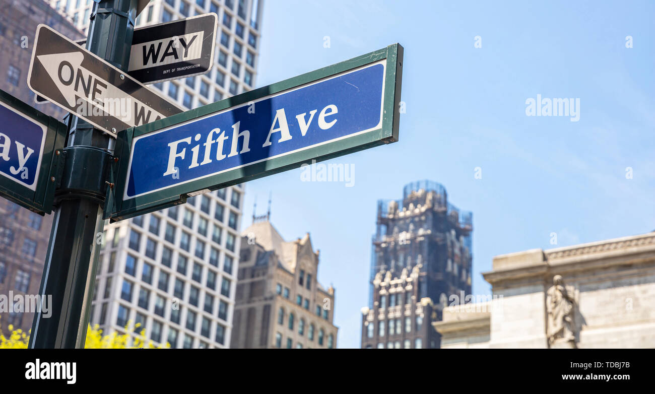 Fifth ave street sign, Manhattan New York downtown. Blue sign on blur ...
