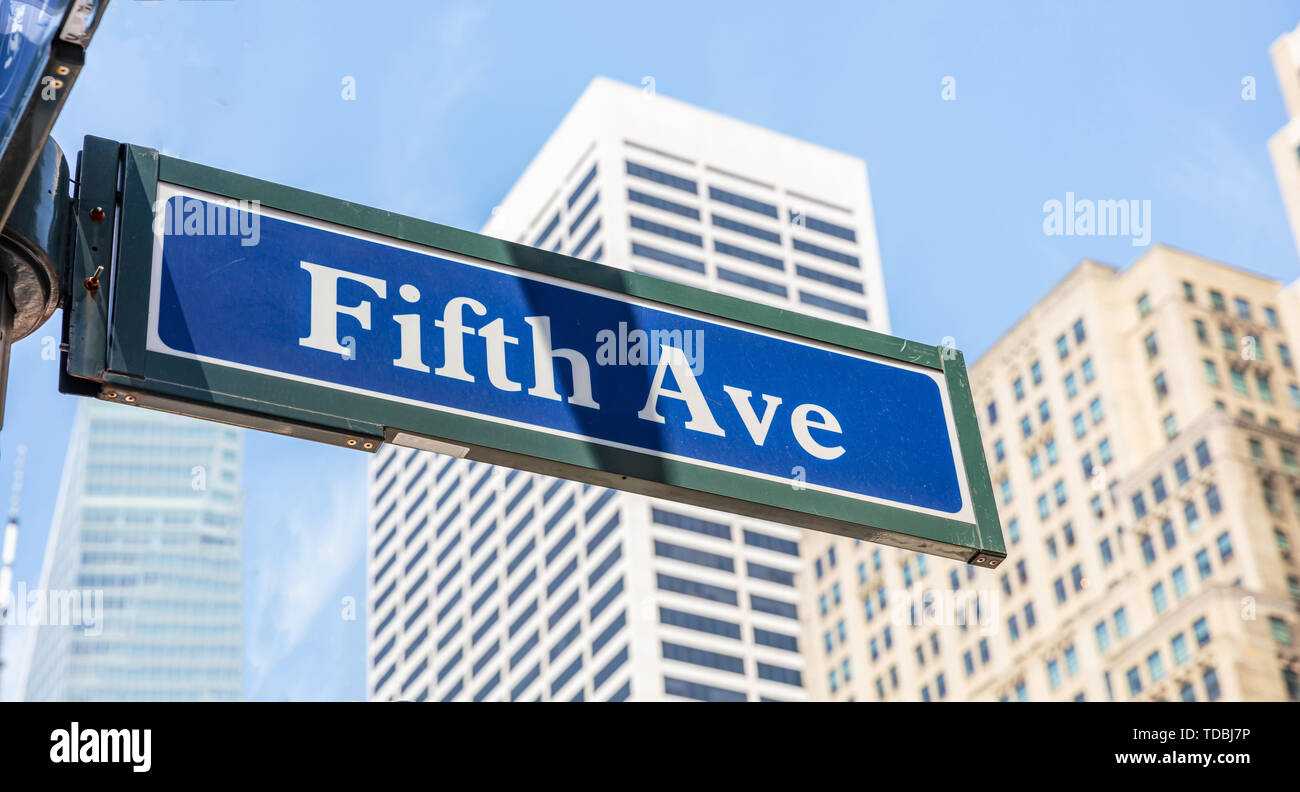 Fifth ave street sign, Manhattan New York downtown. Blue sign on blur ...