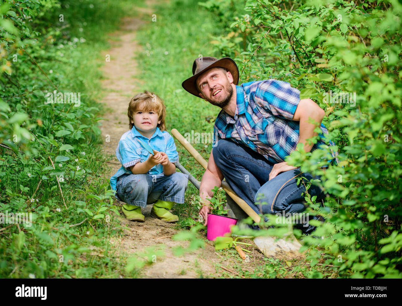 Eco farm. hoe, pot and shovel. Garden equipment. small boy child help ...