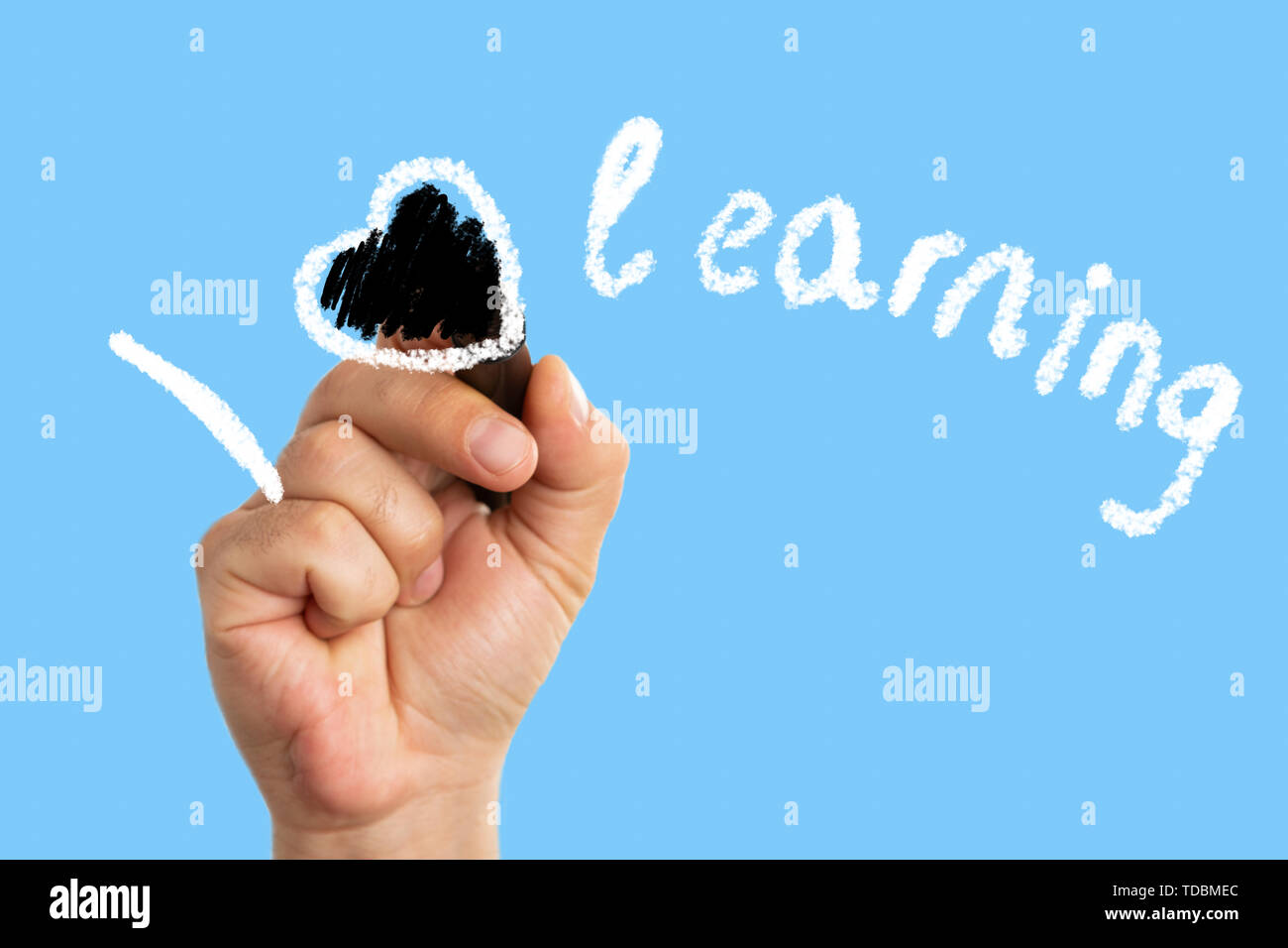 Closeup of man colouring heart symbol with black marker in i love ...