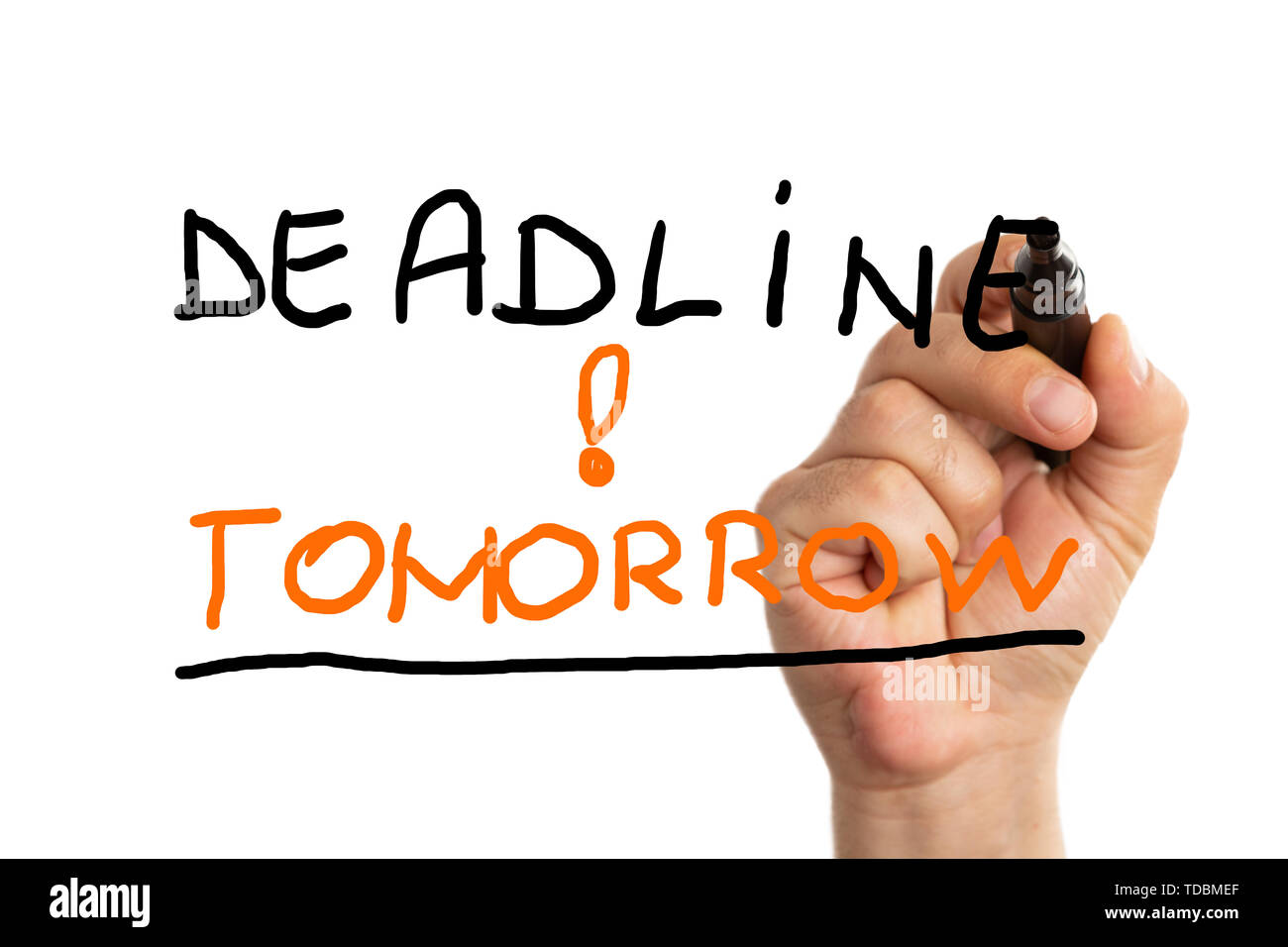 Man writing deadline tomorrow reminder on board with orange and black ...