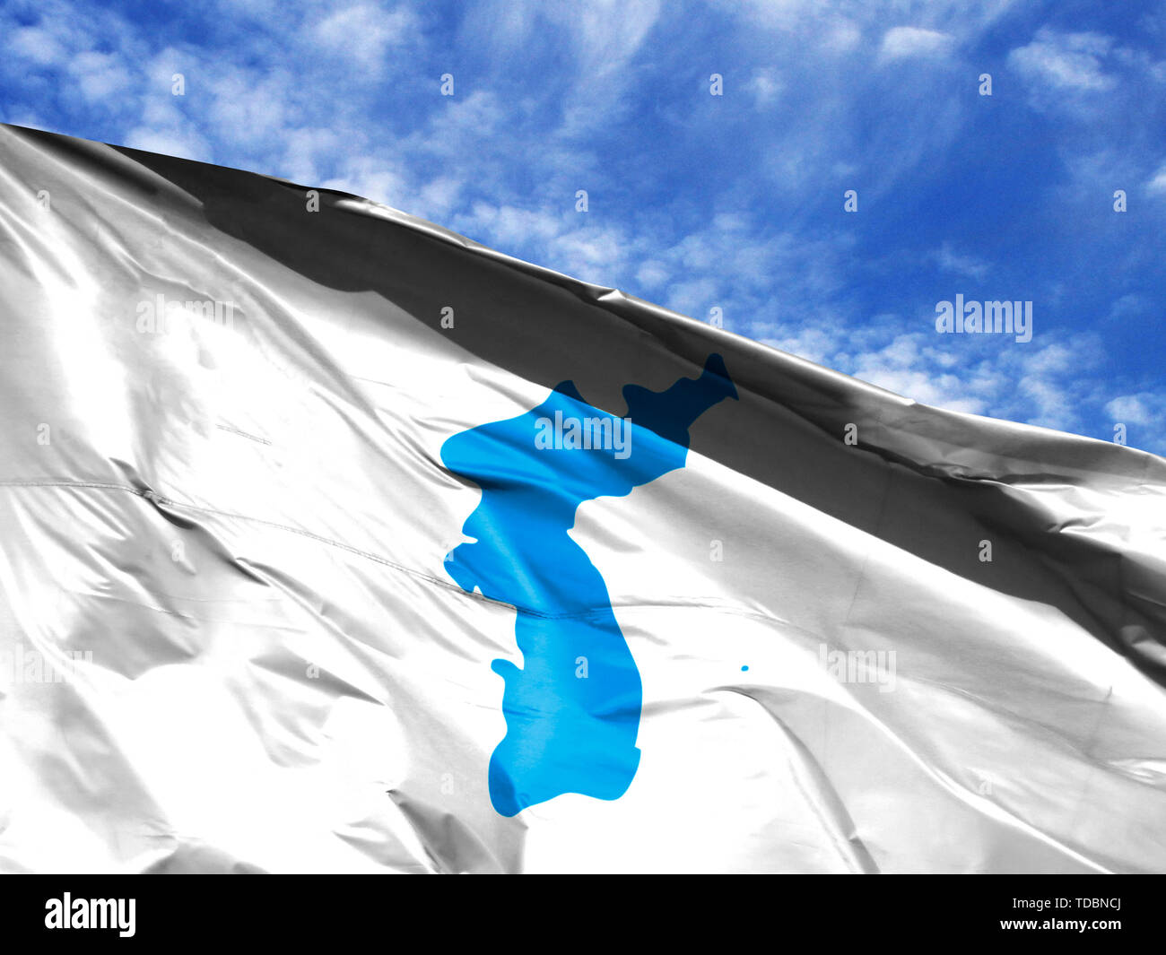 waving flag of Korean Unification close up against blue sky Stock Photo ...