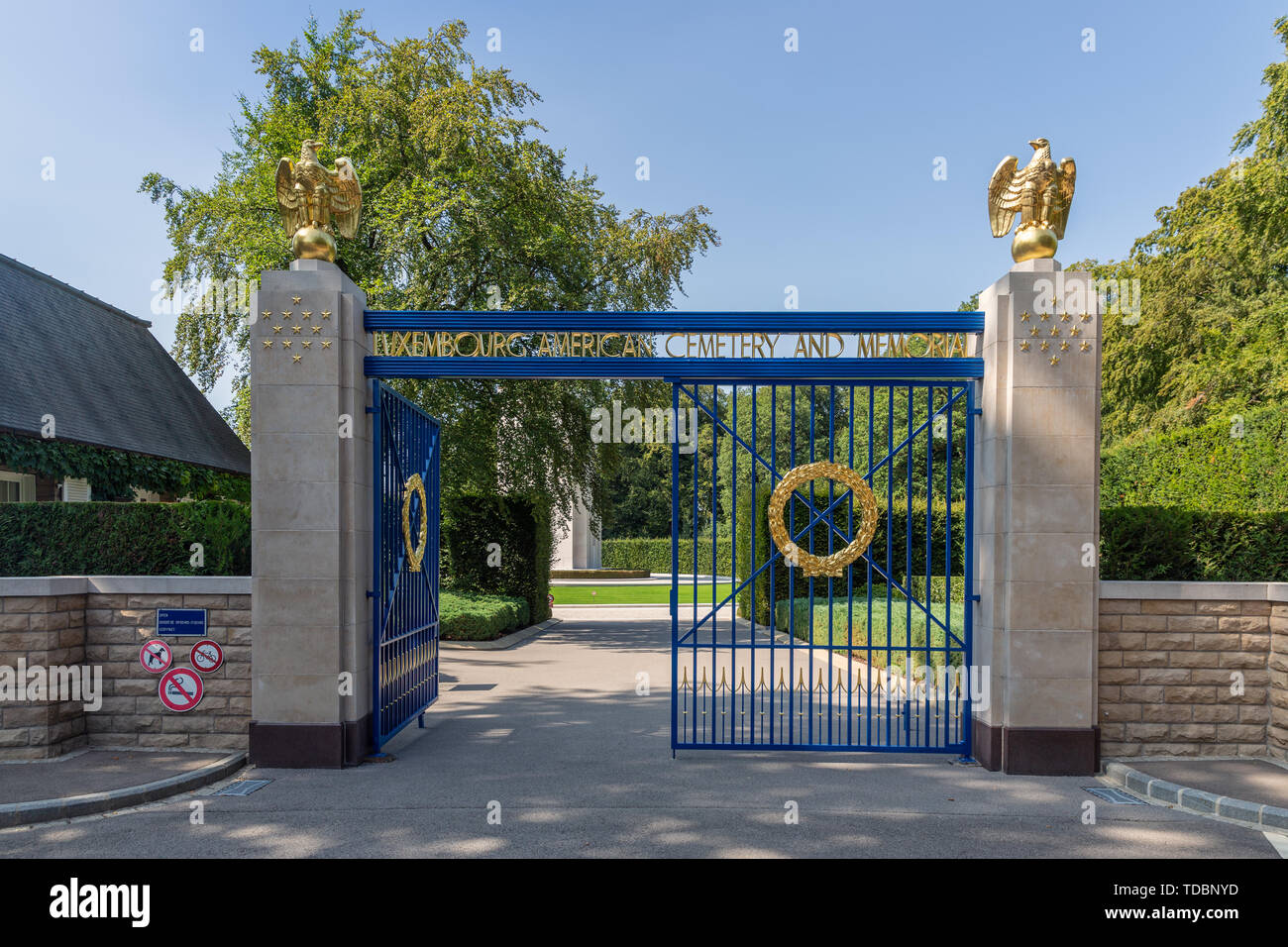 Entrance American WW2 Cemetery with iron gate and gold eagles Stock ...