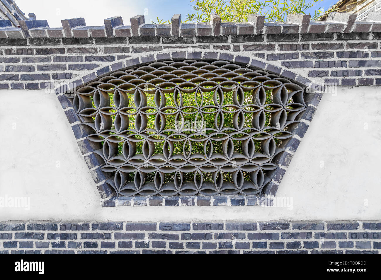 Garden wall tile hollowed-out window Stock Photo - Alamy