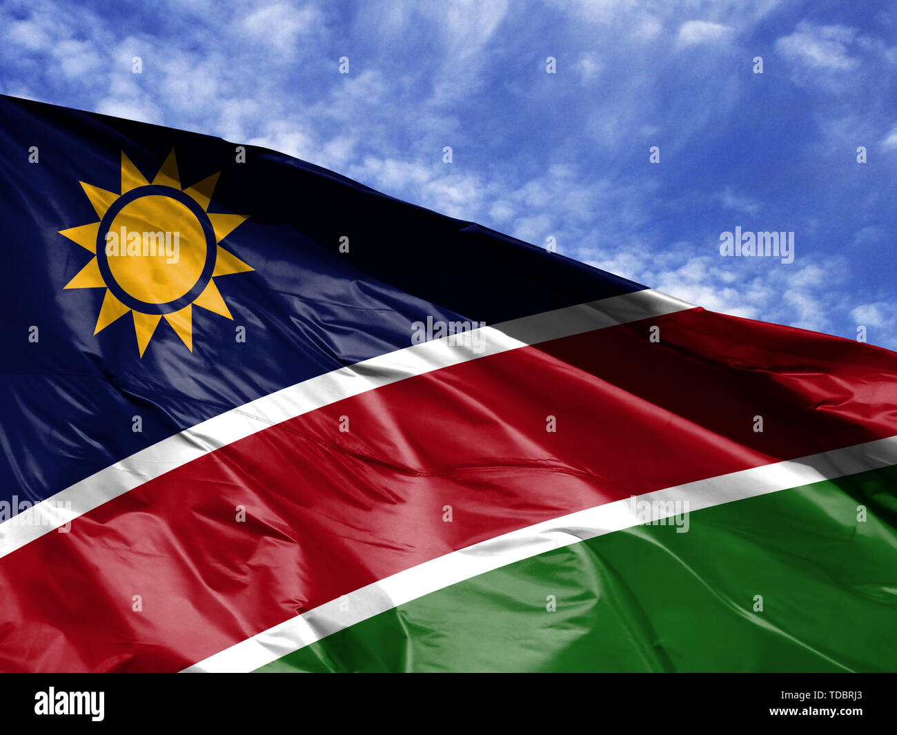 waving flag of Namibia close up against blue sky Stock Photo - Alamy