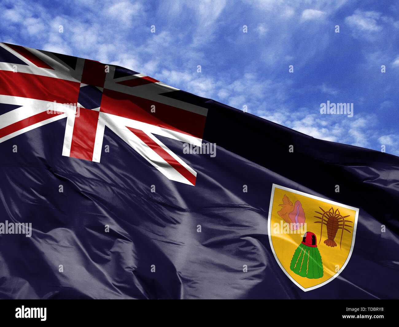 waving flag of Turks and Caicos Islands close up against blue sky Stock ...