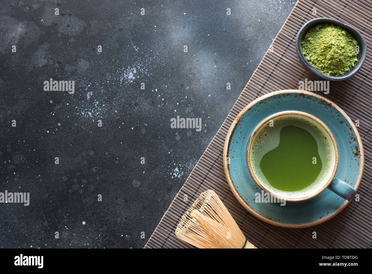 Organic traditional green matcha tea on black table. Top view. Space ...