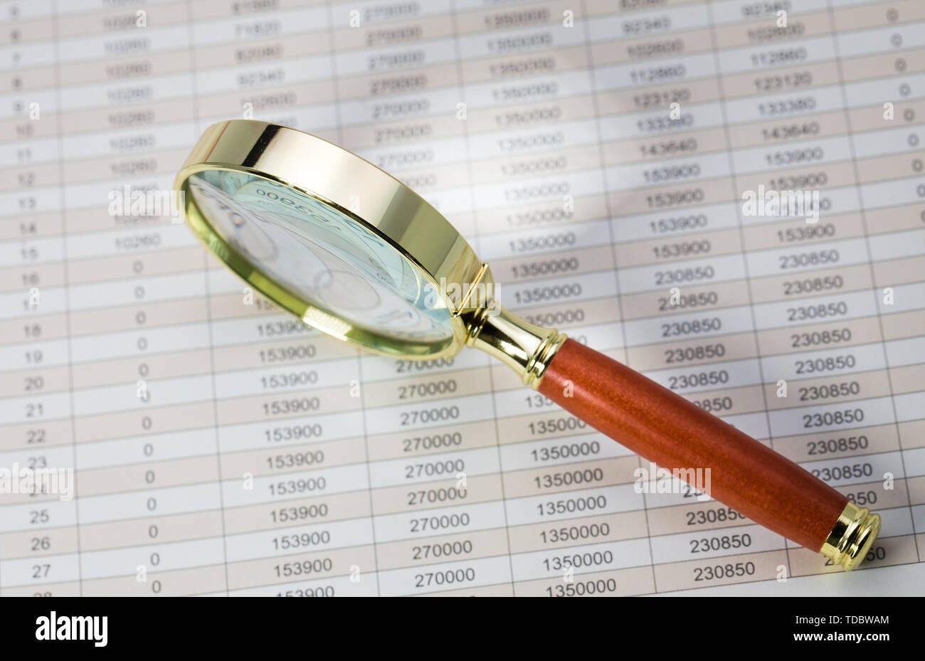 A magnifying glass study data report Stock Photo - Alamy