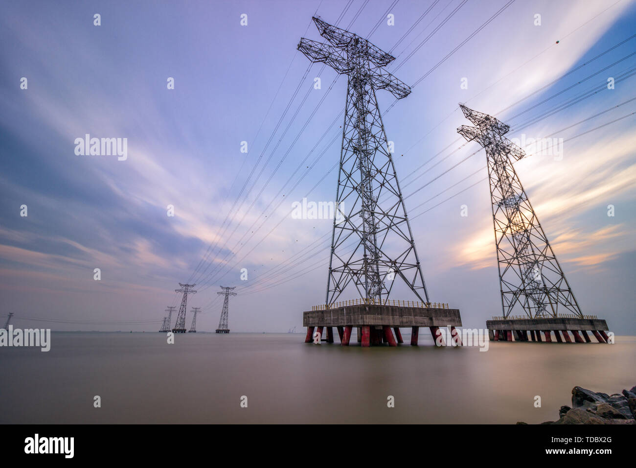 High-voltage wire transmission on the surface of the sea Stock Photo ...