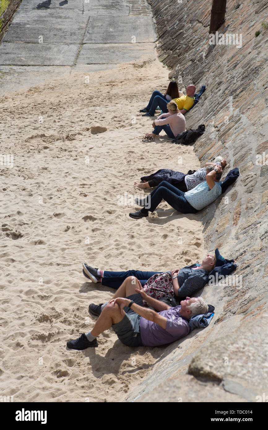 People sunbathing on beach Stock Photo - Alamy