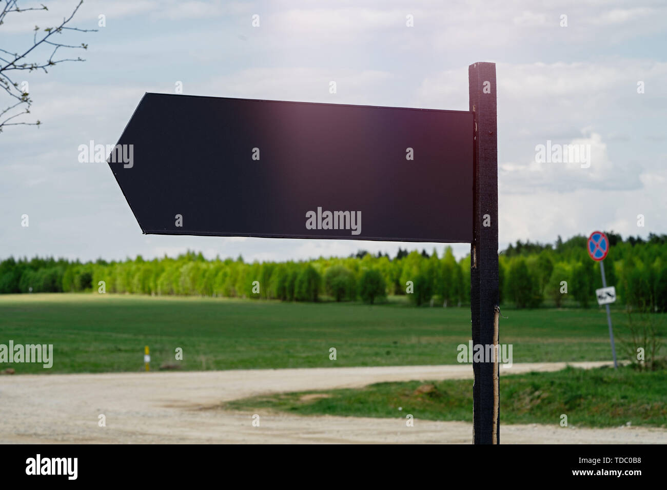 Close up of blank black outdoor road sign board at beautibul lanscape ...
