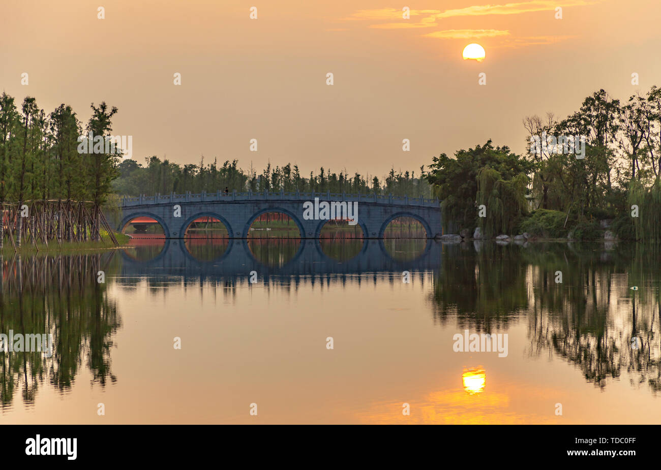 Sunset Lake Bridge Stock Photo - Alamy