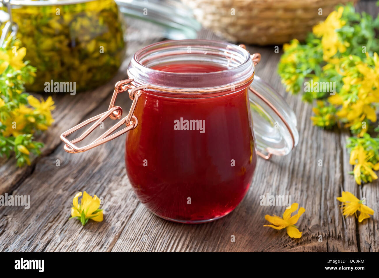 A jar of red oil made from St. John's wort flowers Stock Photo - Alamy