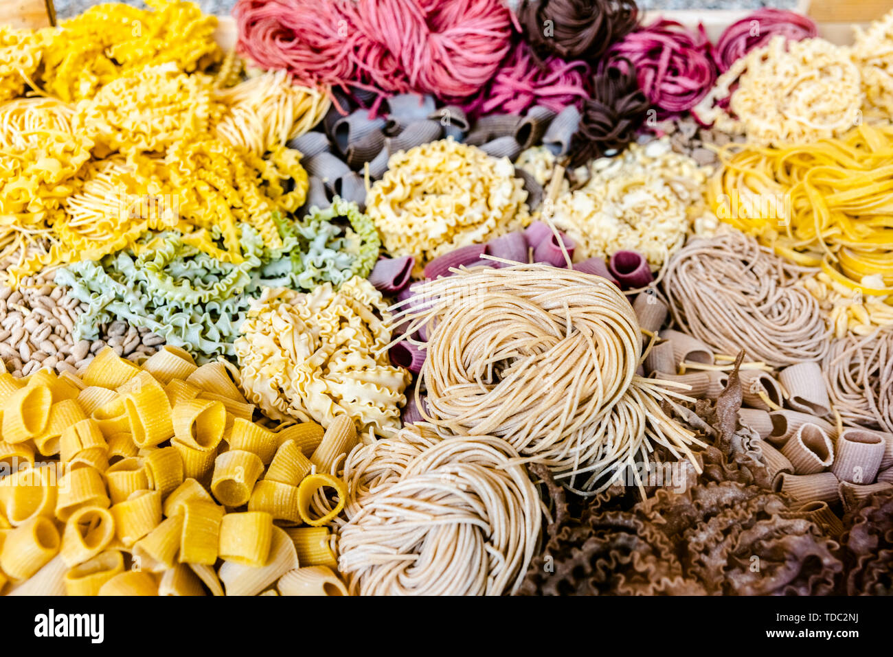 Many types of uncooked Italian pasta of various colors and shapes Stock ...