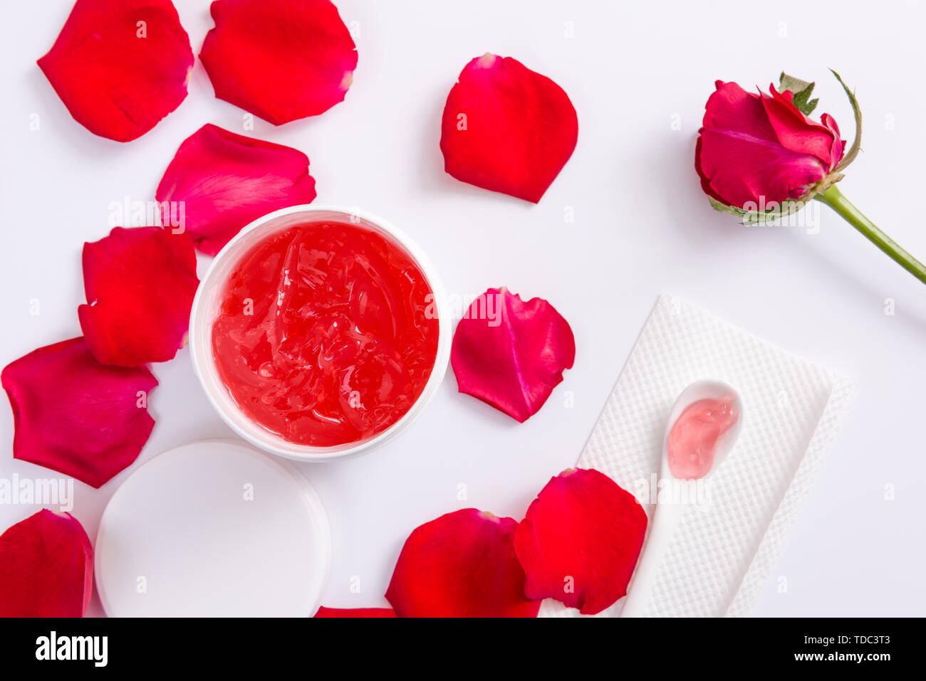 Red rose petals and refined skin care products Stock Photo - Alamy