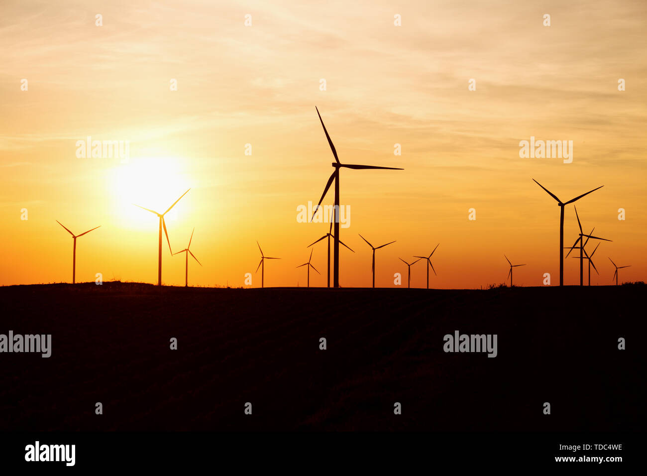Wind Turbines Over Sunset Sky Generating Electricity. Sustainable ...