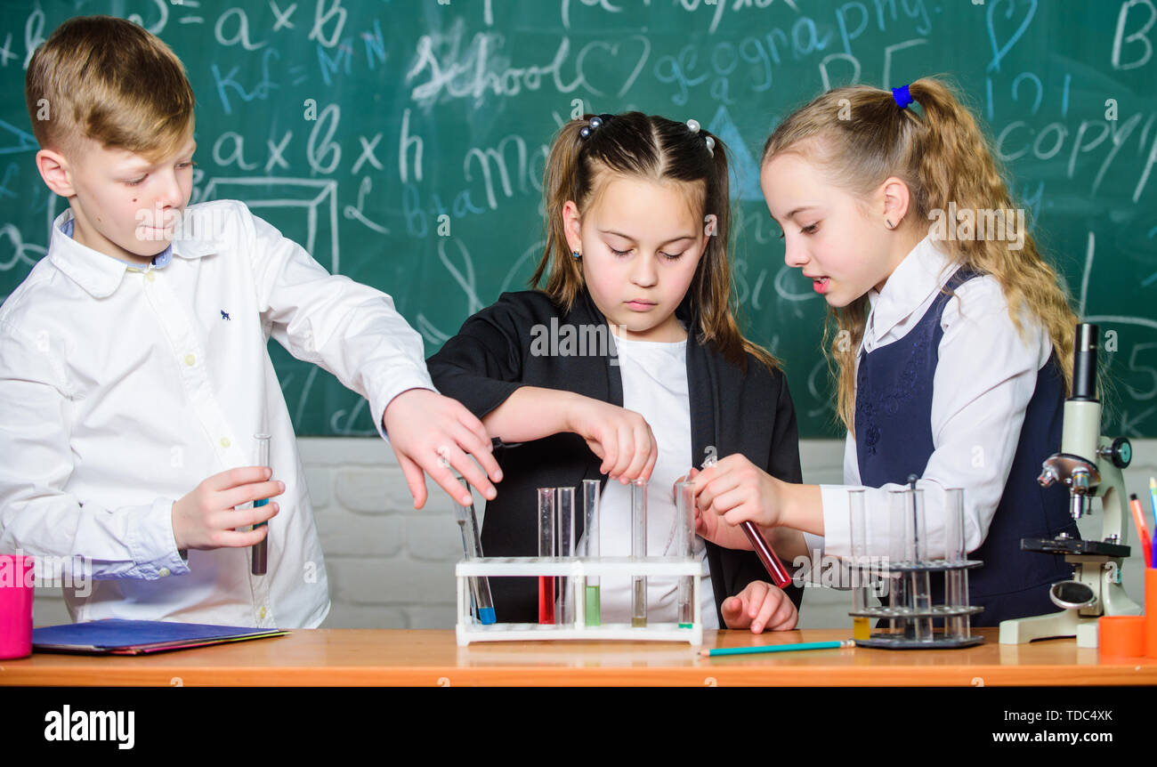 students doing biology experiments with microscope in lab. Little kids ...