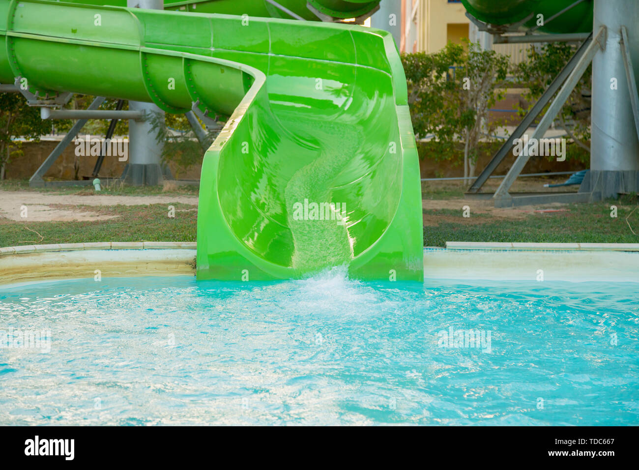 Colourful plastic slides in aquapark in the sunset. sliders, water park ...