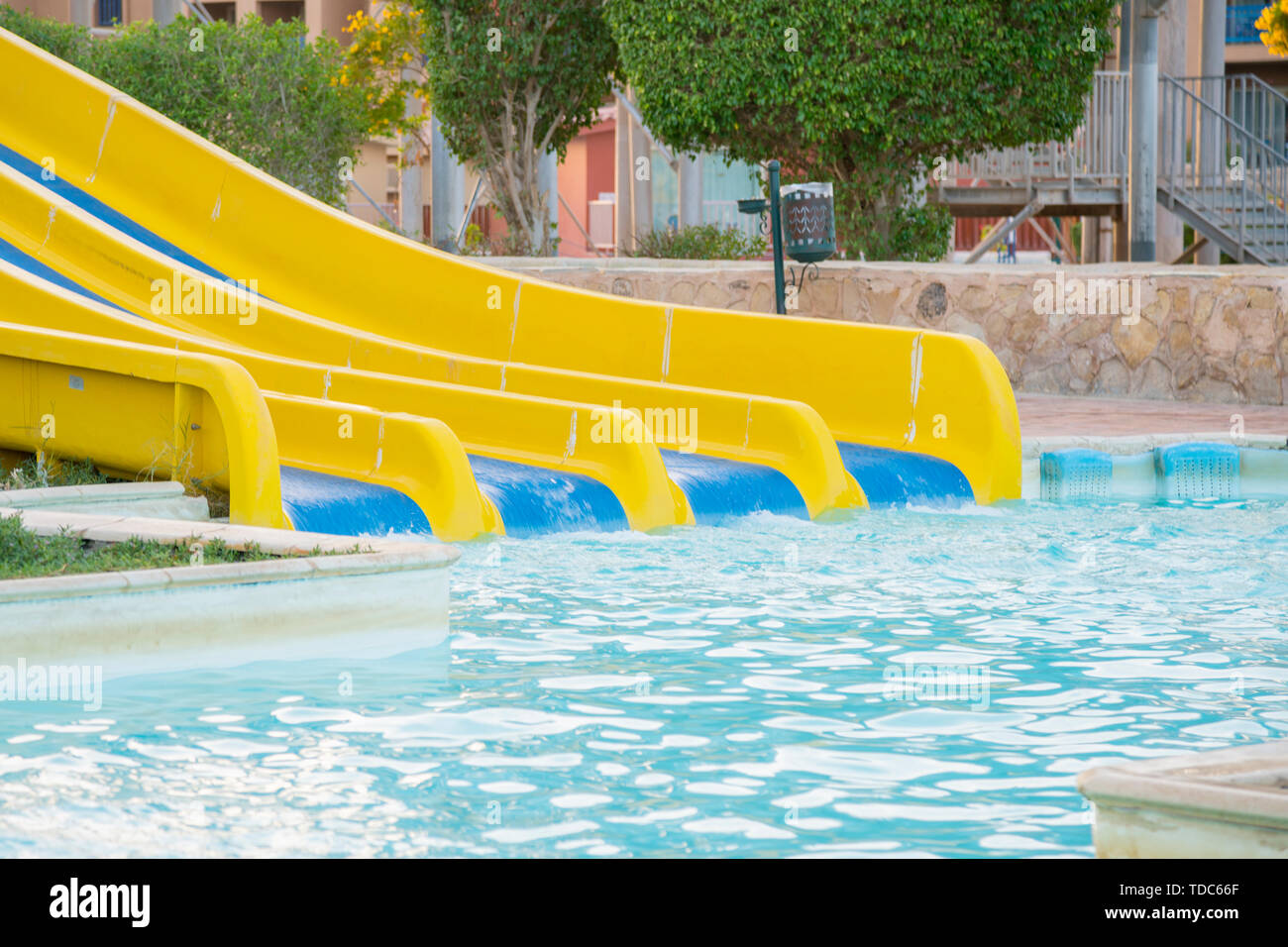Colourful plastic slides in aquapark in the sunset. sliders, water park ...