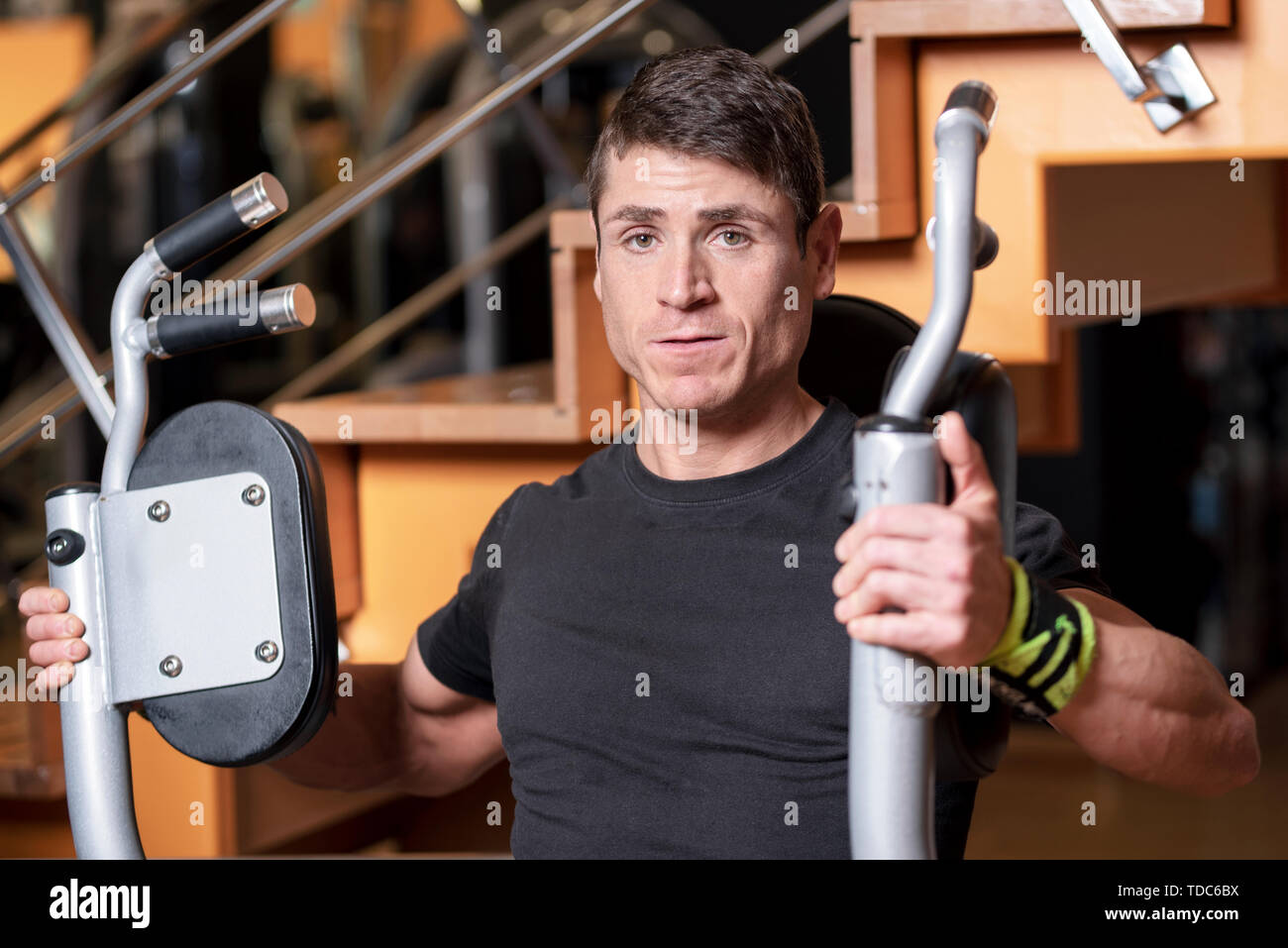 Handsome muscular man working out hard at gym. Training Chest exercises ...