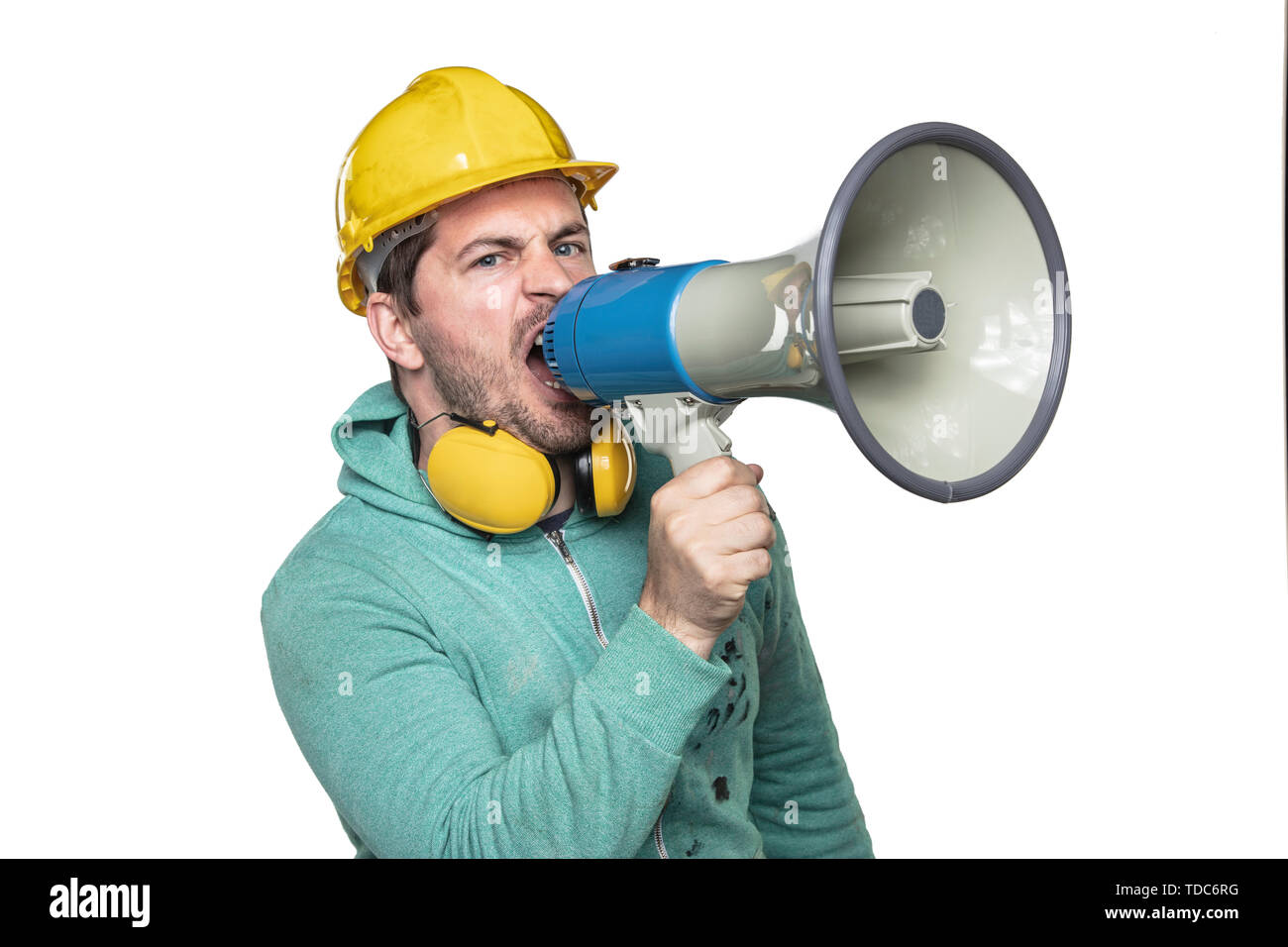 the construction worker holds a megaphone in his hands, the concept of ...