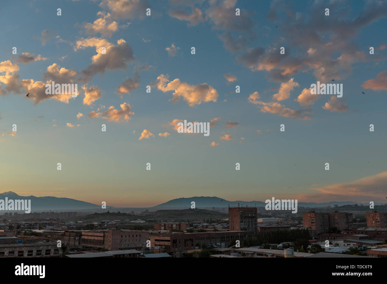 photo of clouds and infrastructure of a small town Stock Photo - Alamy