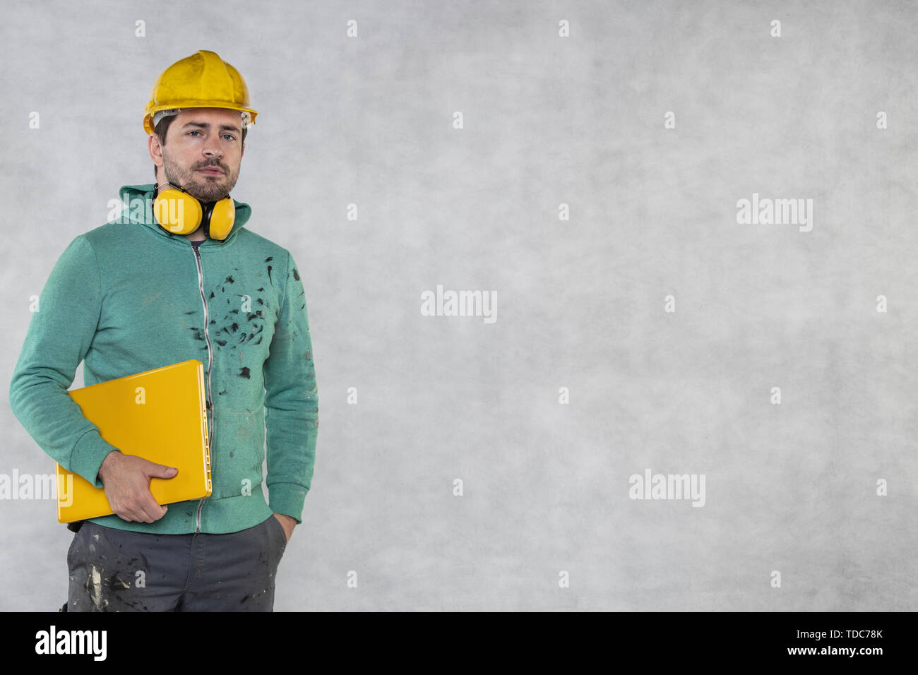 modern building supervisor keeps the computer in his hands, technology ...