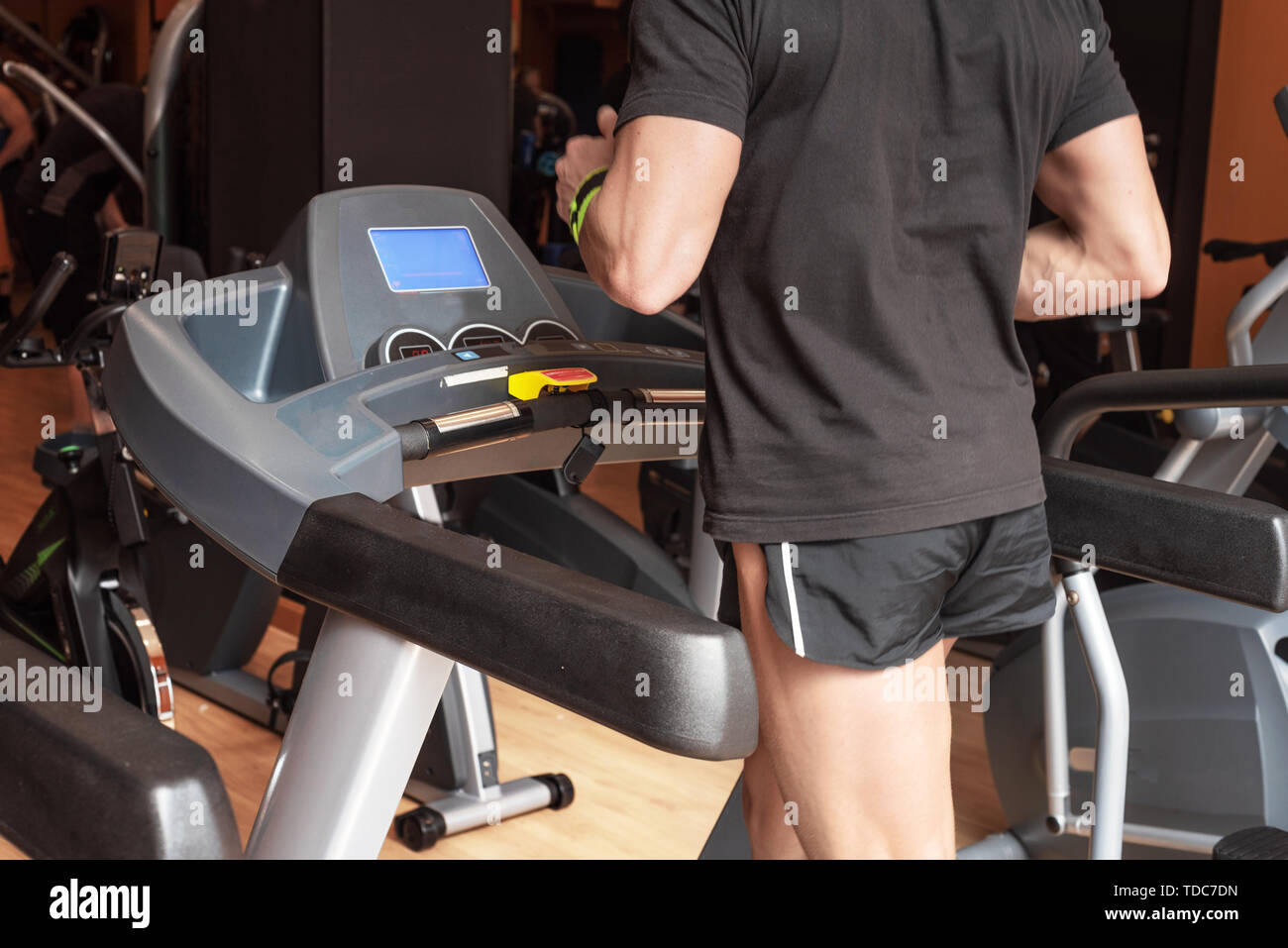 Man running in a modern gym on a treadmill, concept for exercising ...