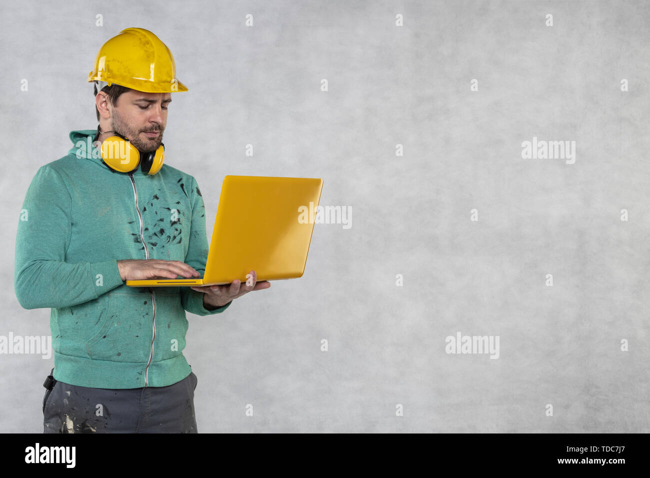 modern building supervisor keeps the computer in his hands, technology ...