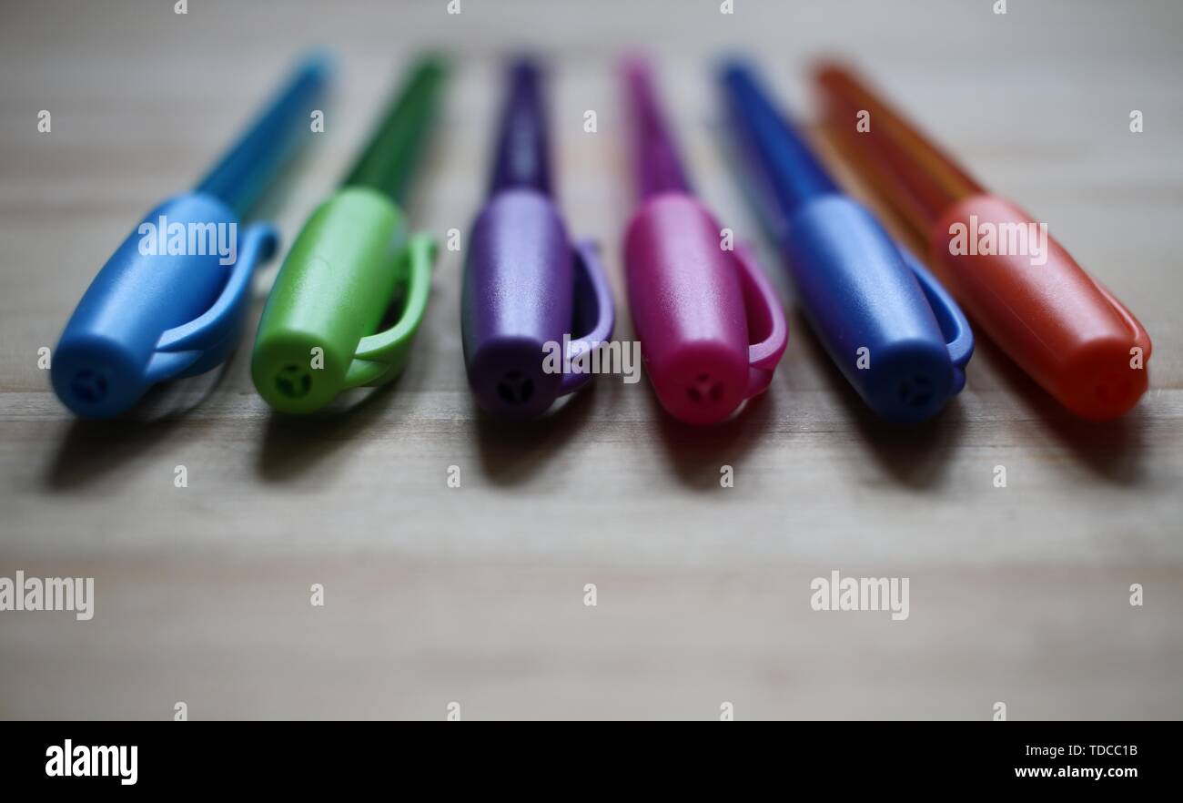Collection of colored pens laid on a table Stock Photo - Alamy